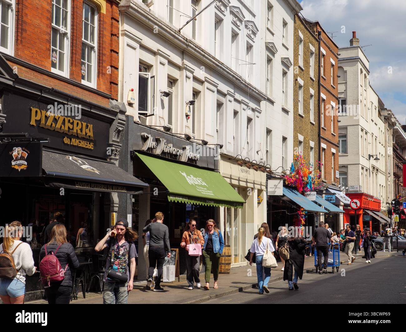 People walking along Old Compton Street, Soho, West End, Westminster ...