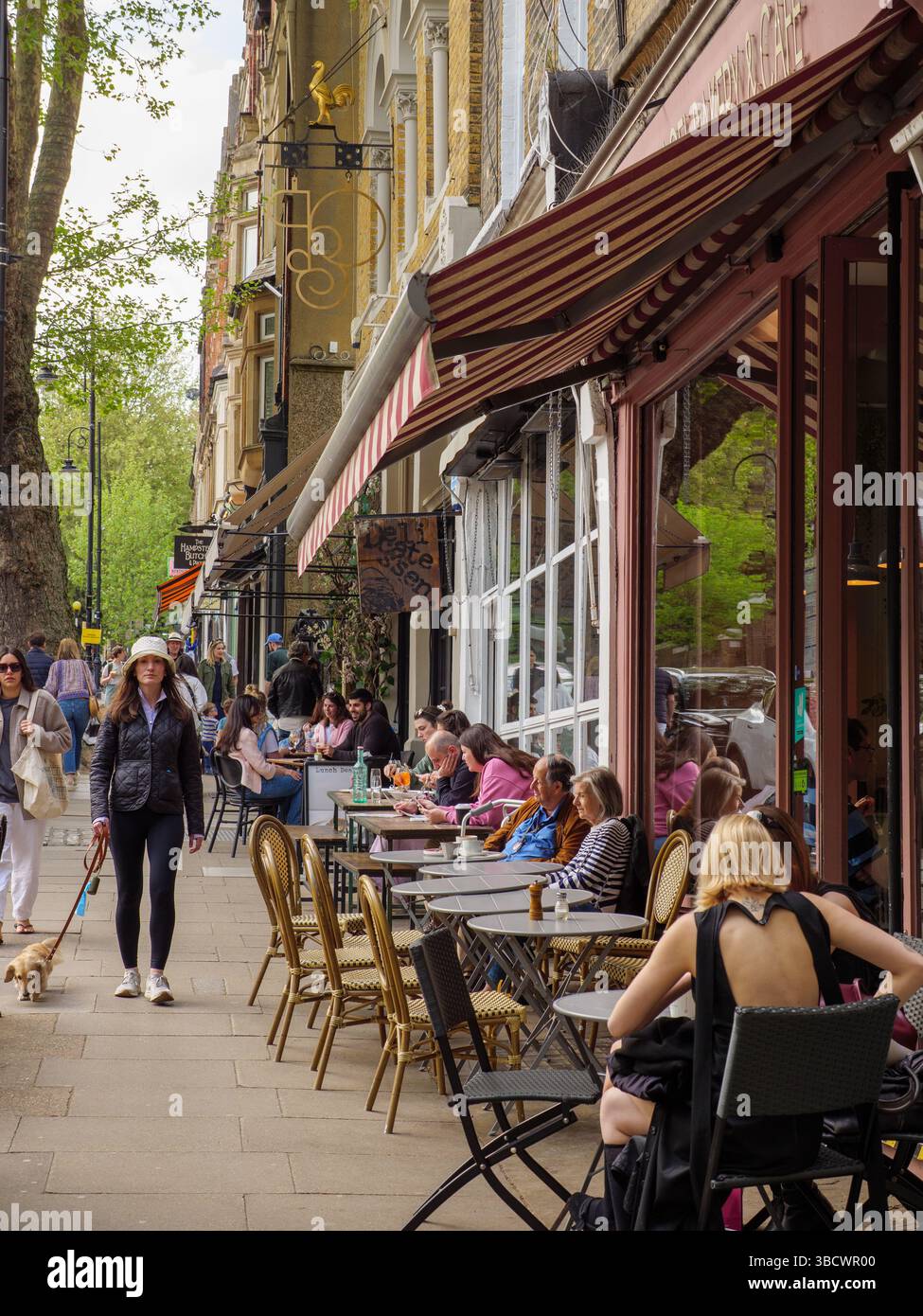 People eating outdoors at restaurant and cafe pavement tables on ...