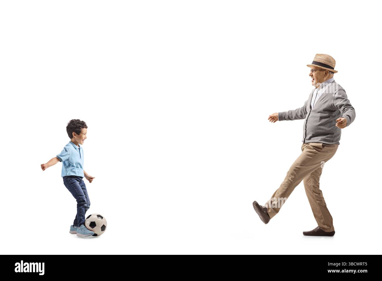 Senior man and kid playing football isolated on white background Stock ...