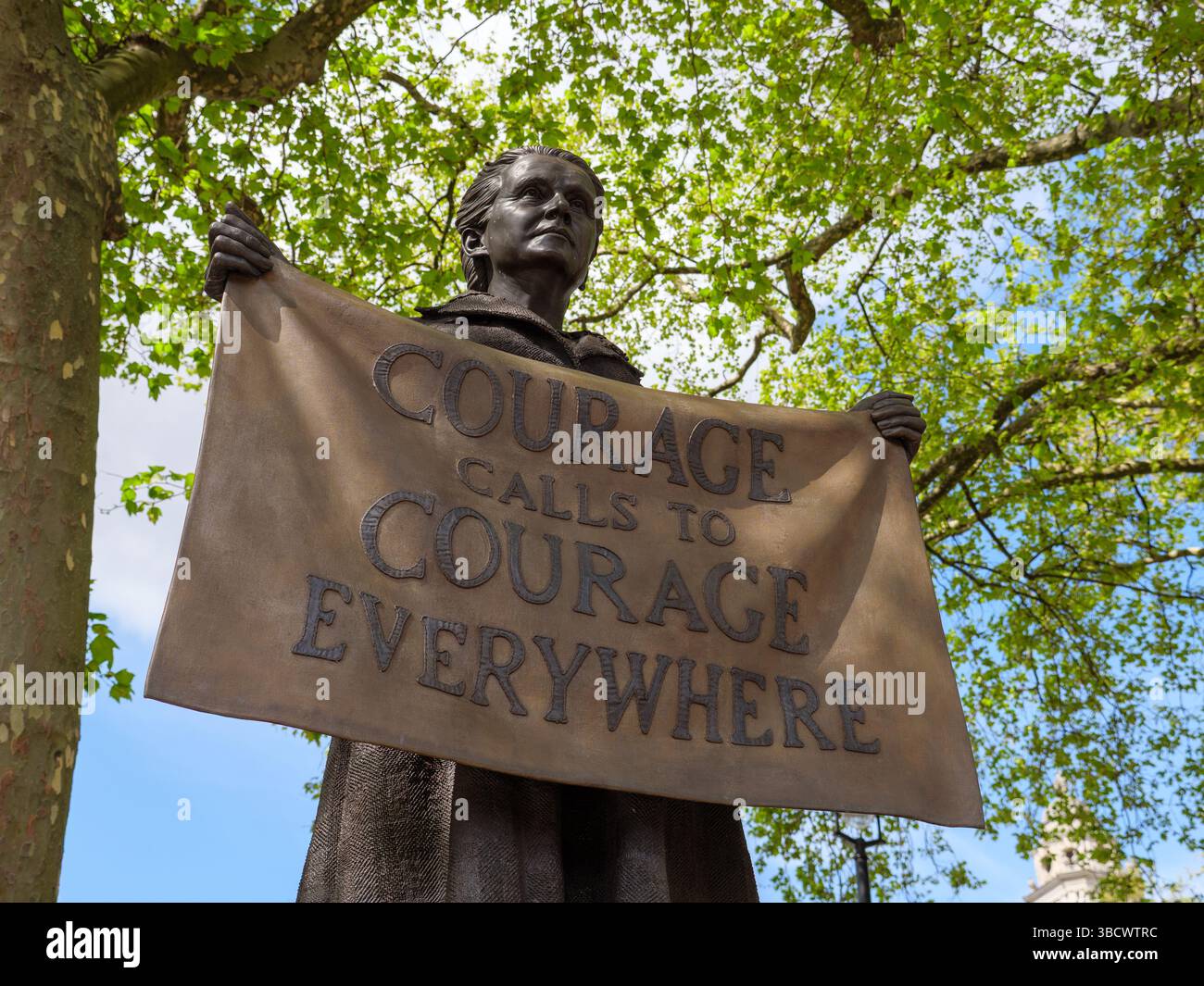 Statue of suffragette Millicent Fawcett holding banner saying "Courage ...