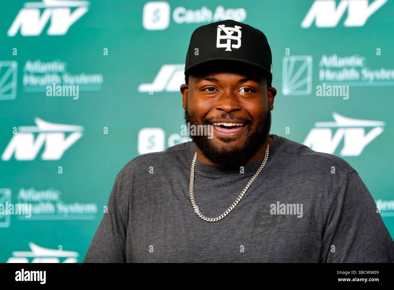 New York Jets guard John Simpson answers questions during a news ...