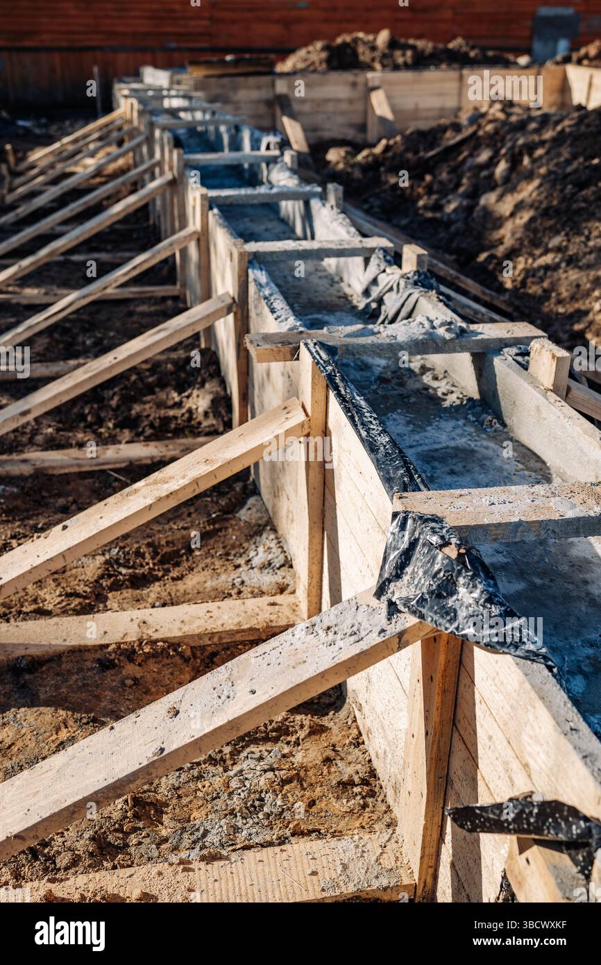 Wooden Formwork Is Supporting Strip Foundation Made Of Concrete Reinforcement And Waterproofing
