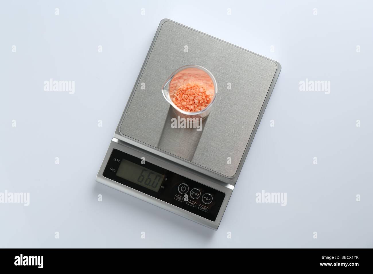 Laboratory scale with beaker of sample on white background, top view ...