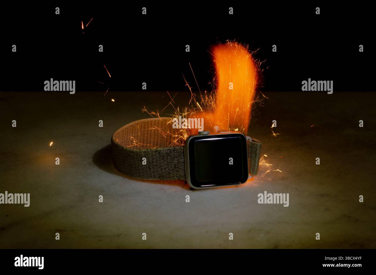 burning smartwatch with a braided strap. The fire engulfing the modern ...