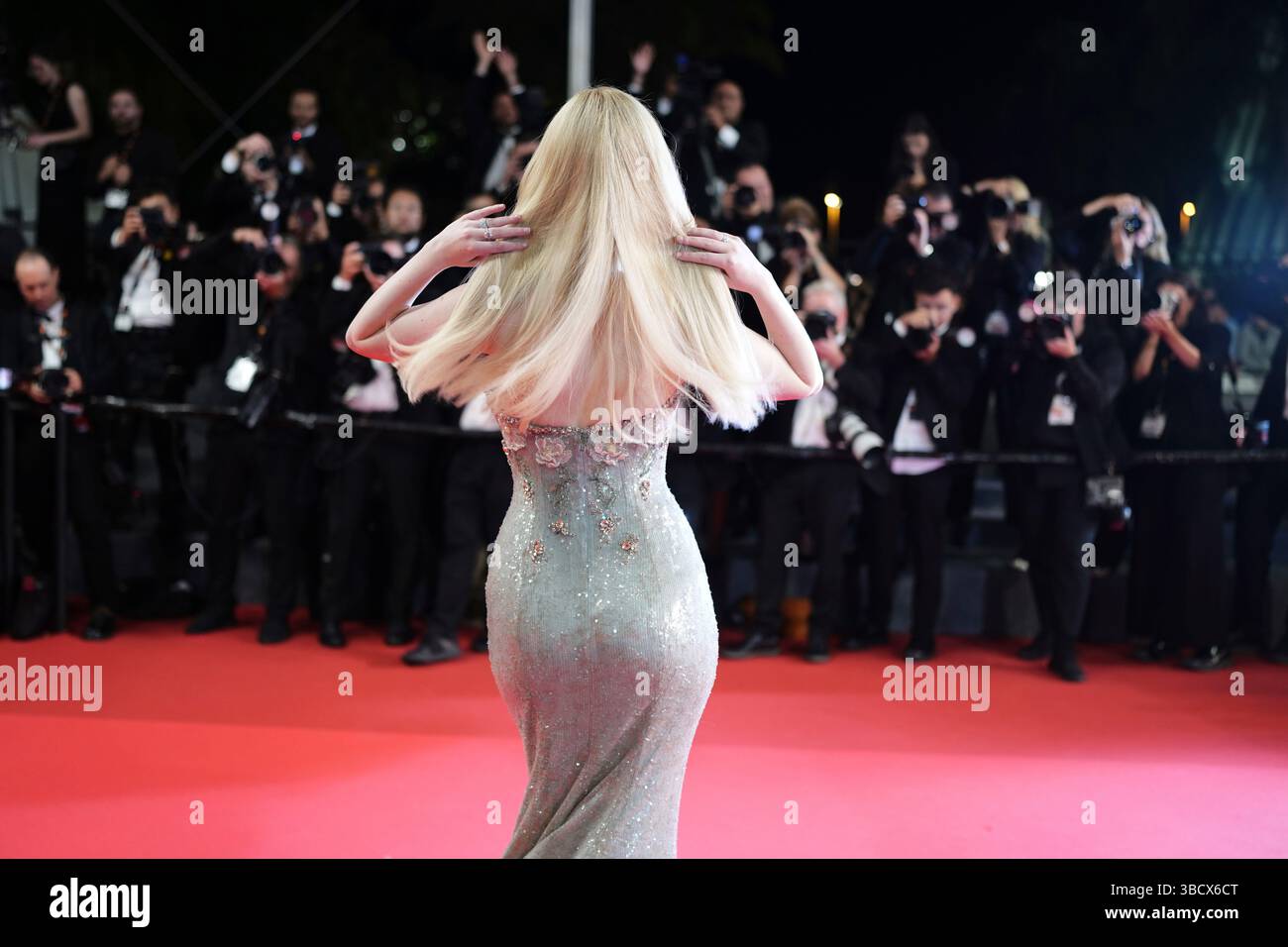 Elle Fanning poses for photographers upon departure from the premiere ...
