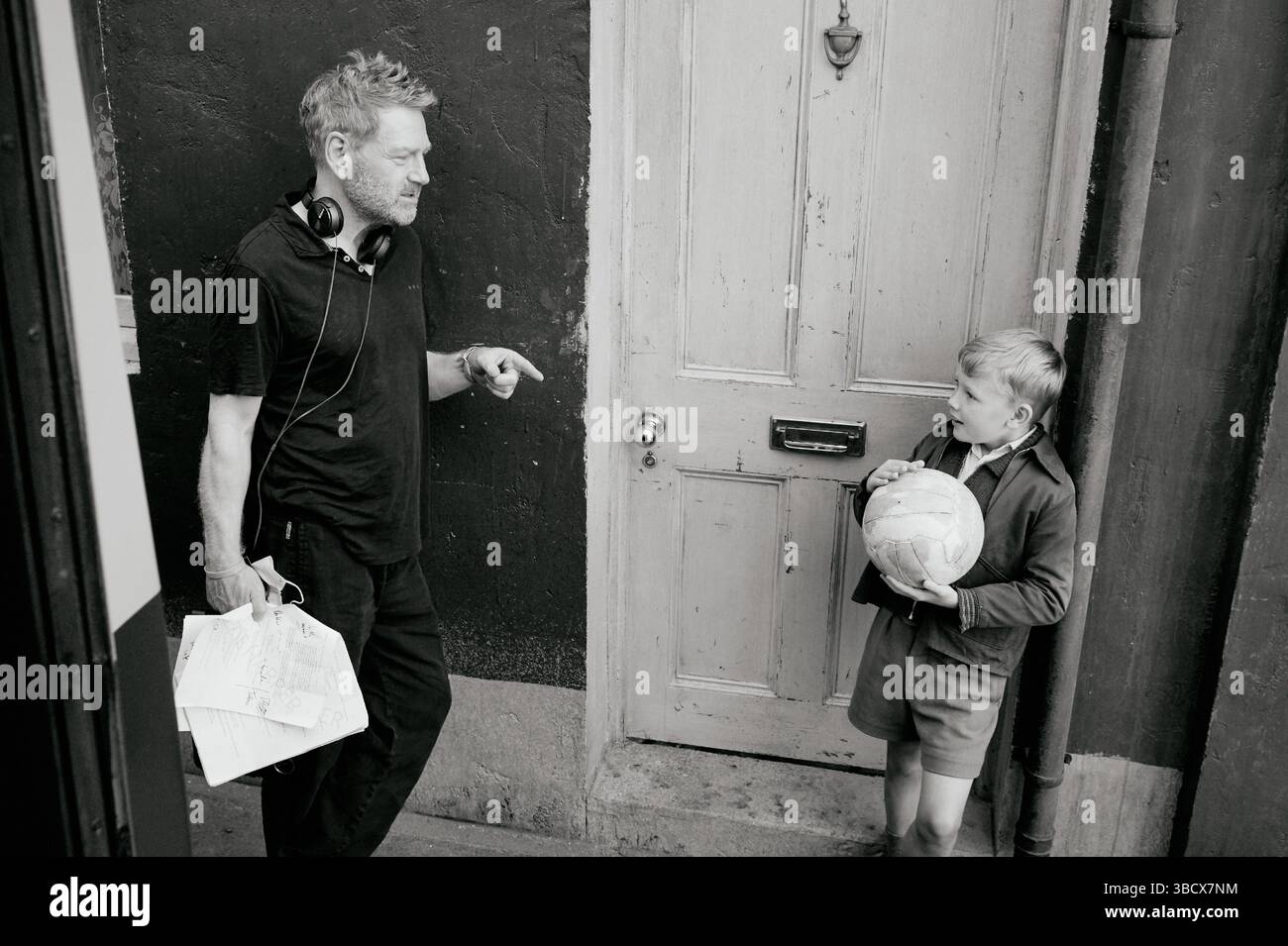 Director Kenneth Branagh (left) and actor Jude Hill (right) on the set ...