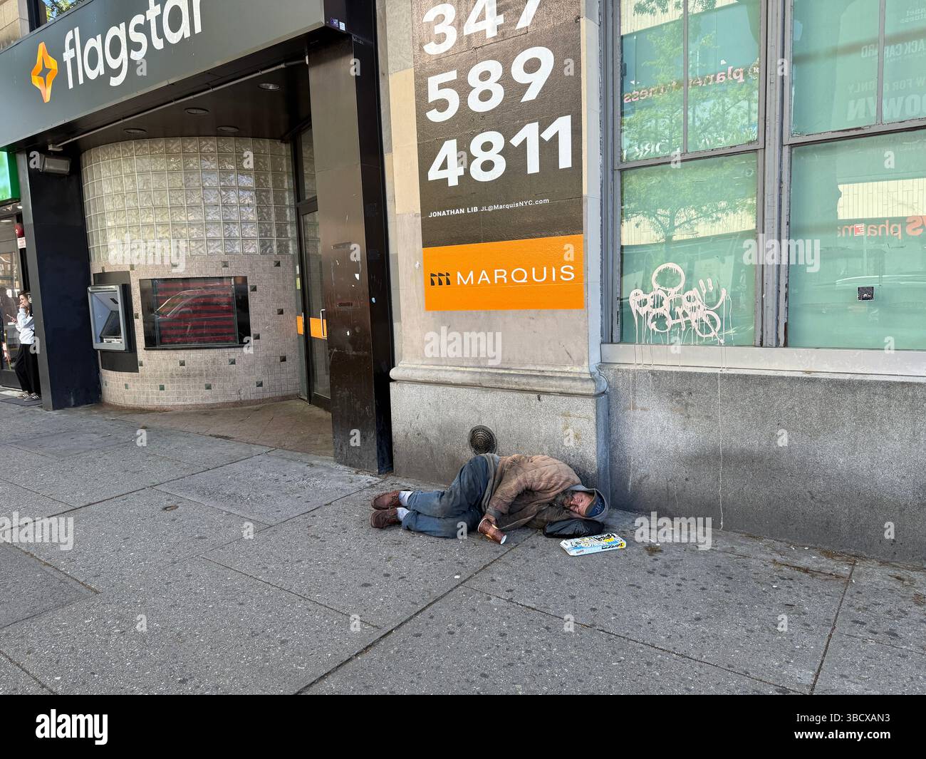 An unfortunate man down and out sleeping on a sidewalk in Brooklyn, New ...