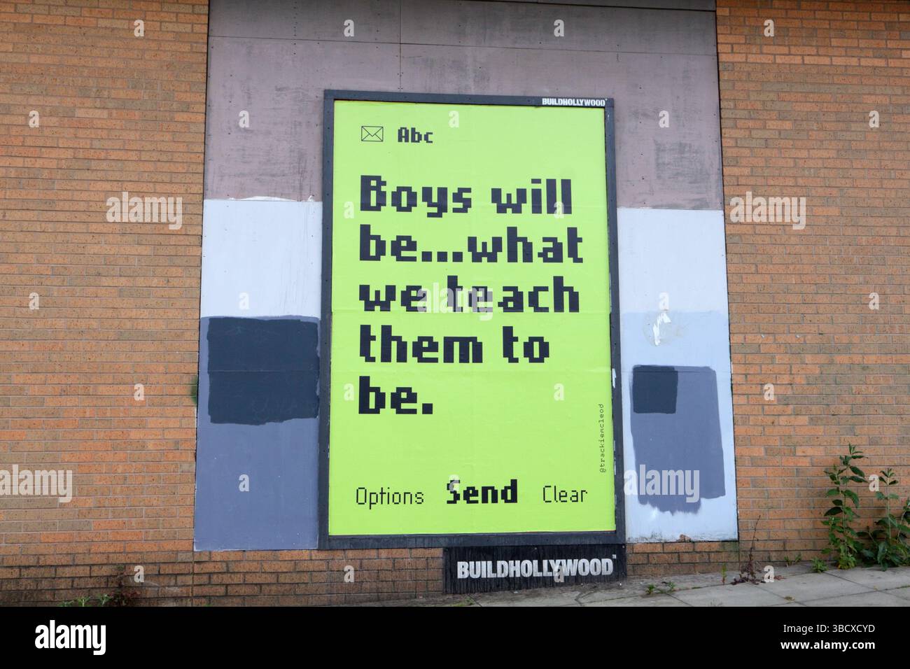 A billboard on a building wall Boys will be what we teach them to be ...