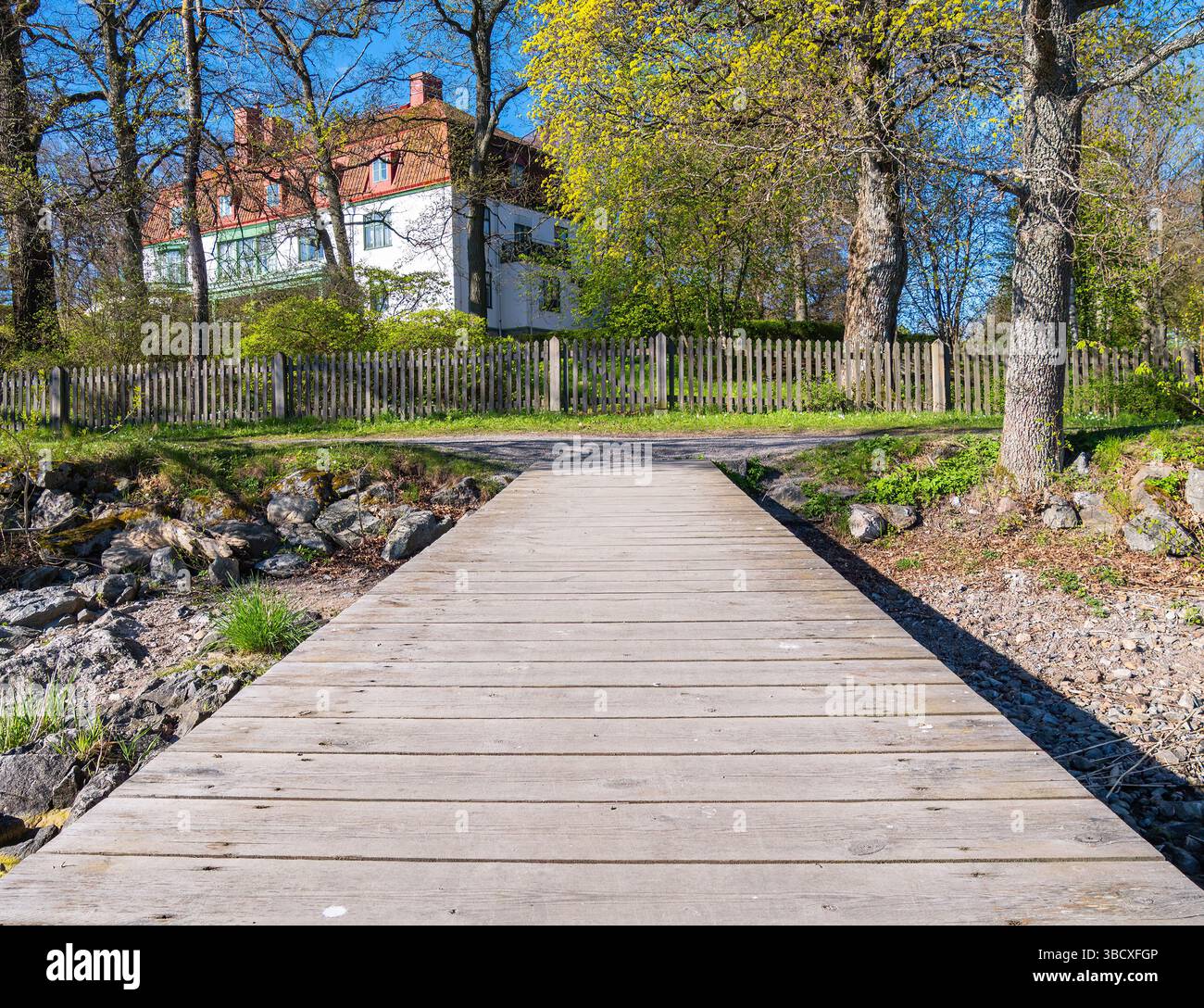 Stockholm, Sweden - April 29th 2025: A wooden dock leading towards a ...