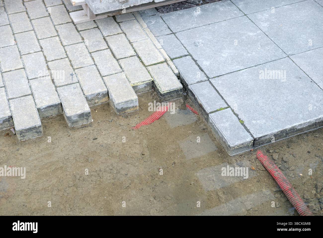paver installation in progress with flexible work tubs, preparing ...