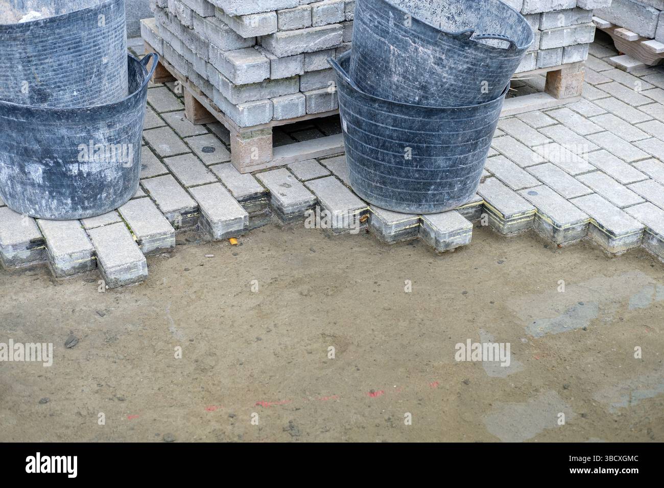construction background stacked paving blocks and work buckets ...