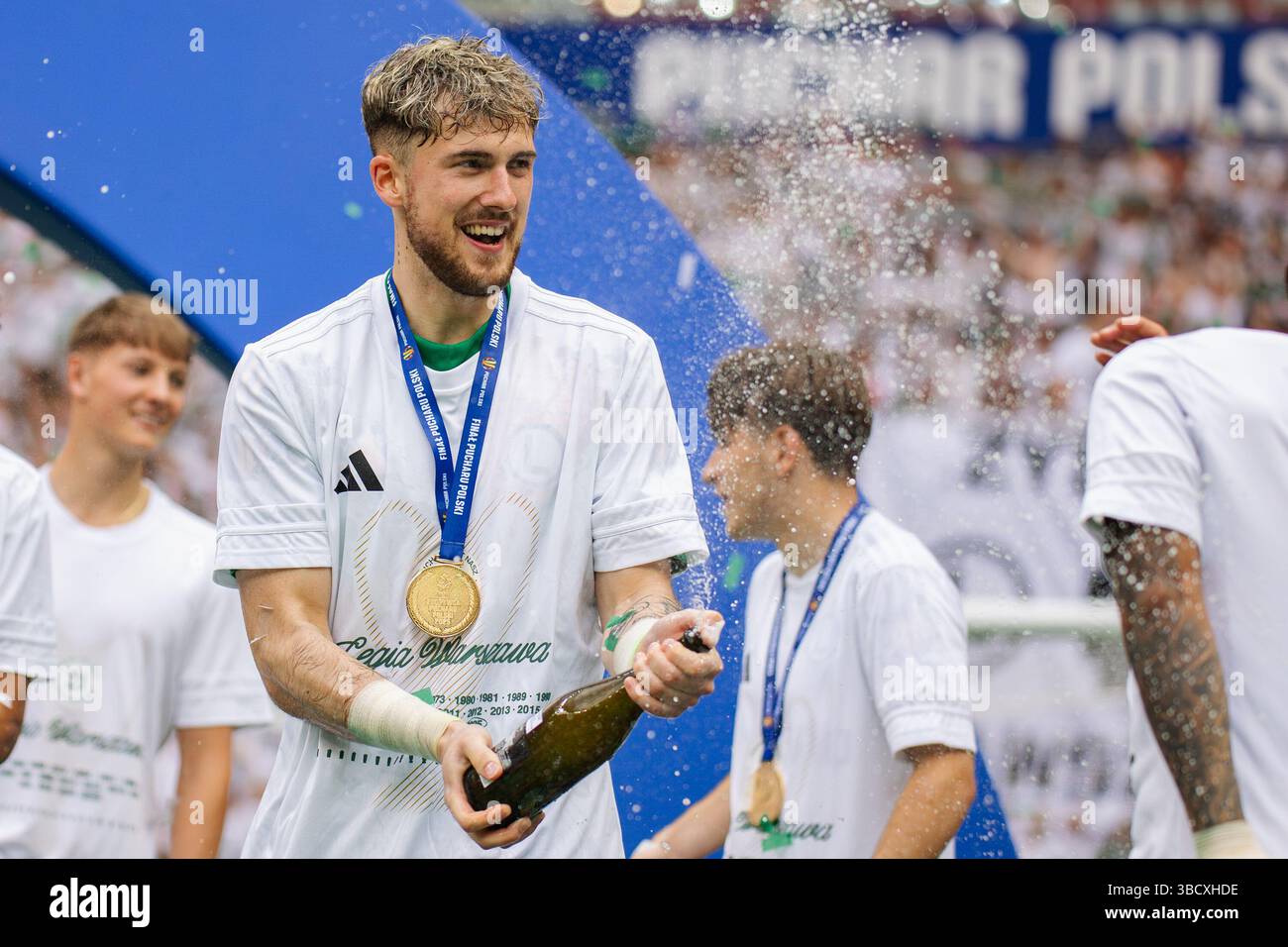 Kacper Tobiasz of Legia celebrates a win with champagne during the ...