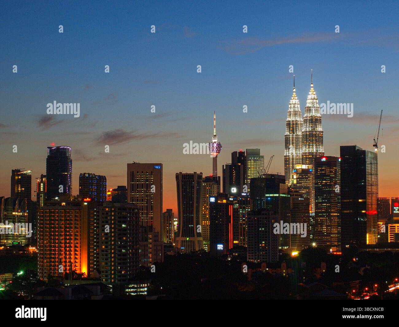 Kuala Lumpur cityscapes during sunset with building lights Stock Photo ...