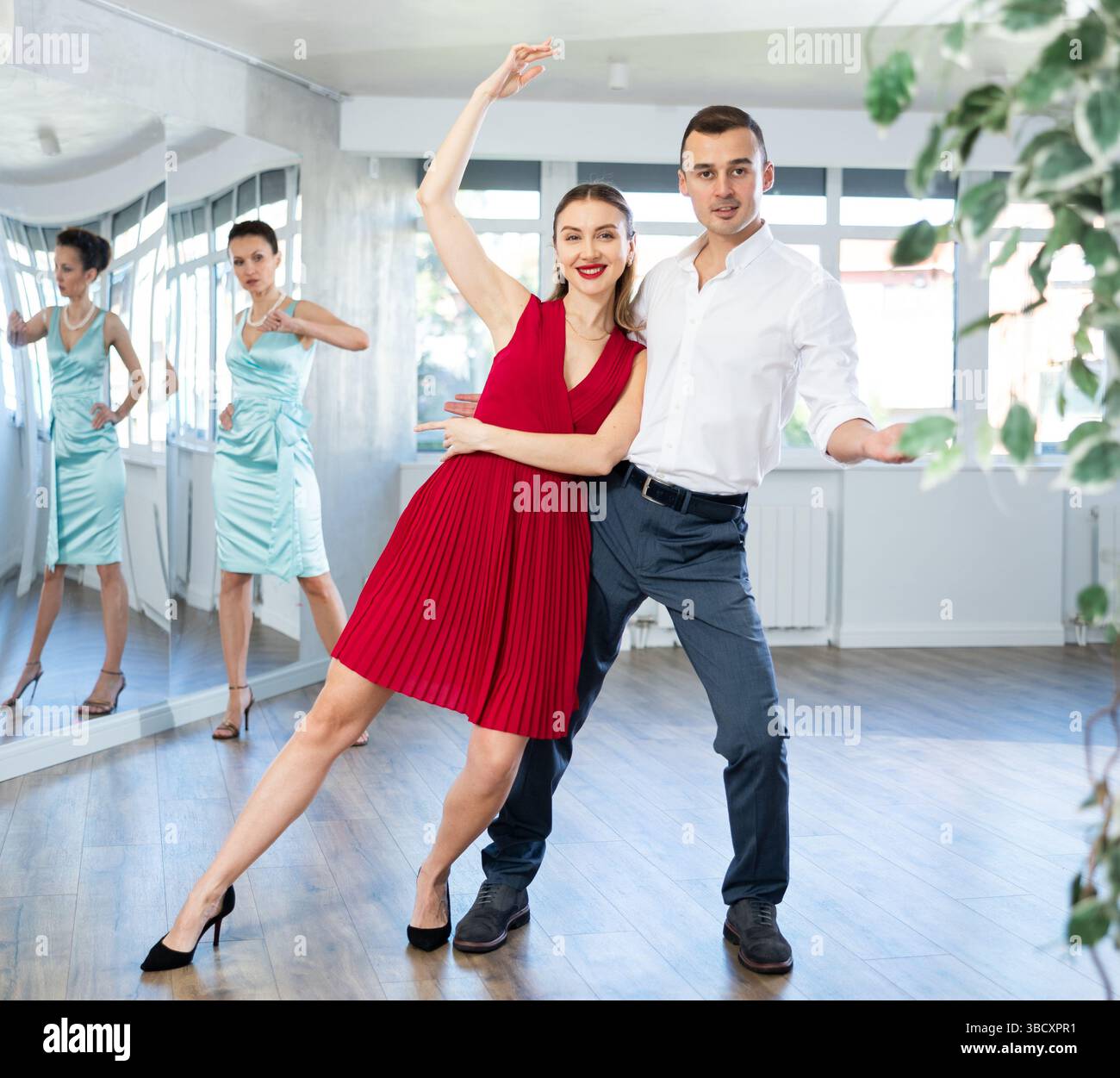Couple in stage costumes learns tango dancing during individual lesson ...