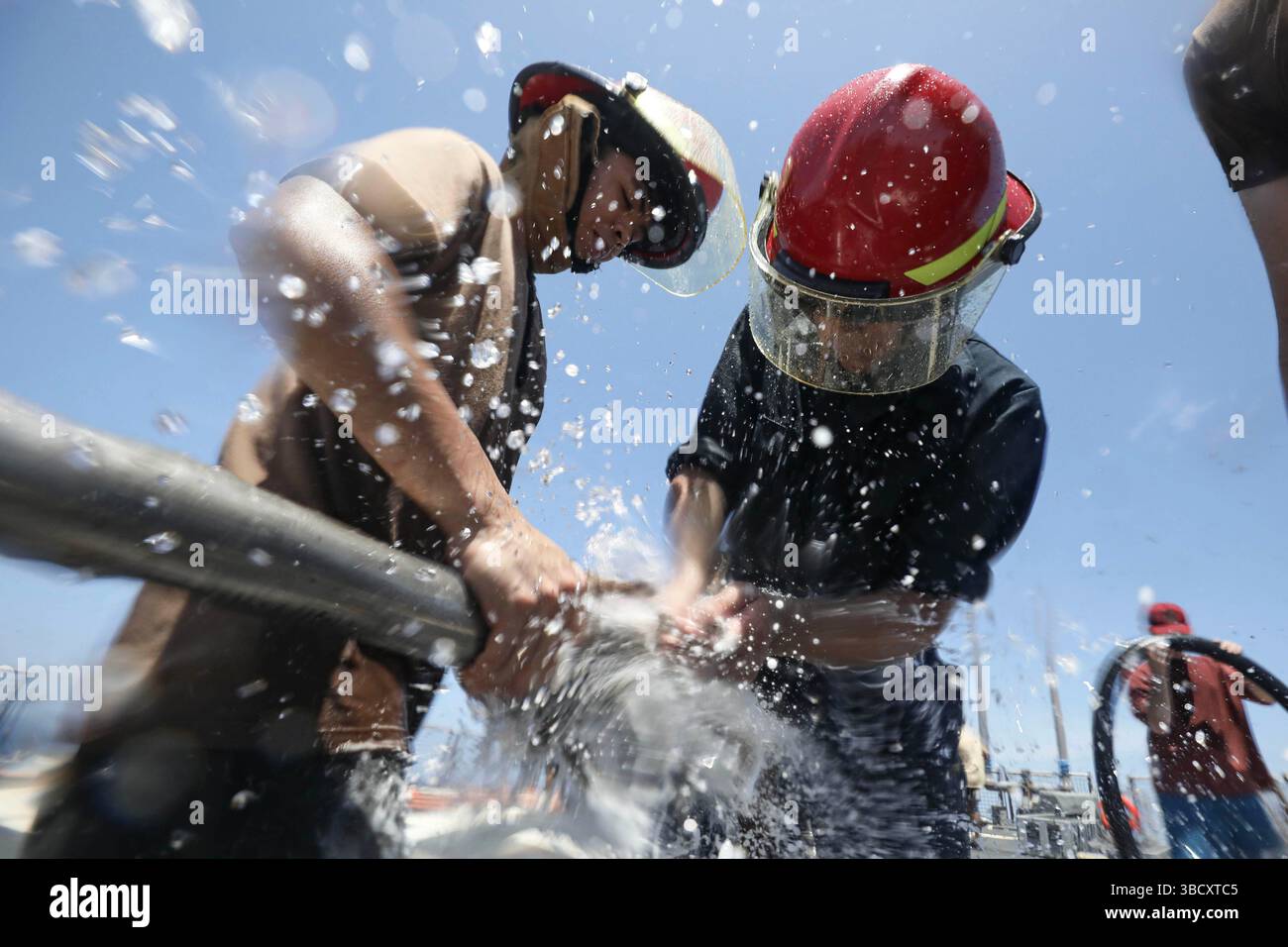 U.S. Sailors patch a leaking pipe during damage control training on the ...