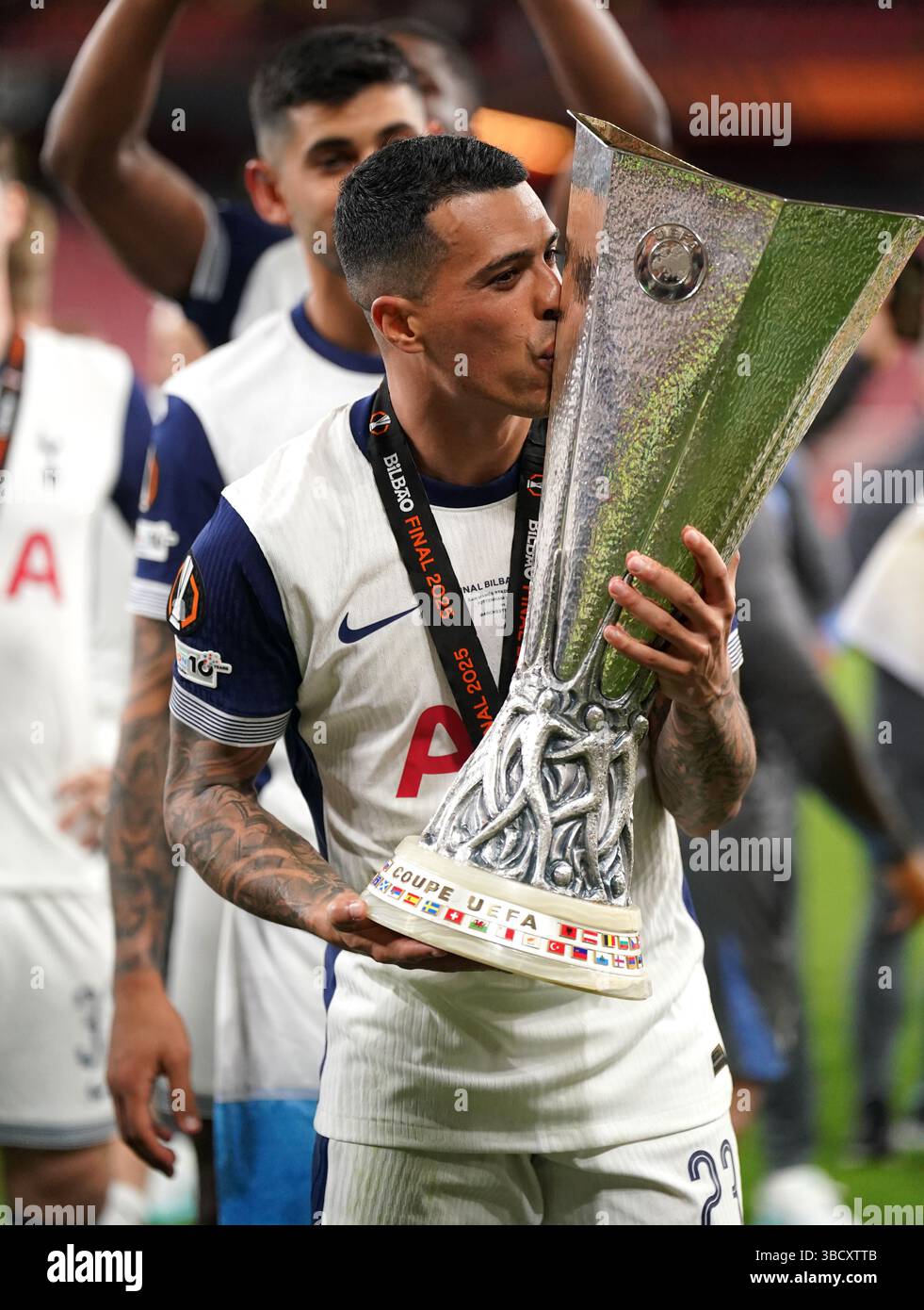 Tottenham Hotspur's Pedro Porro kisses the UEFA Europa League trophy ...