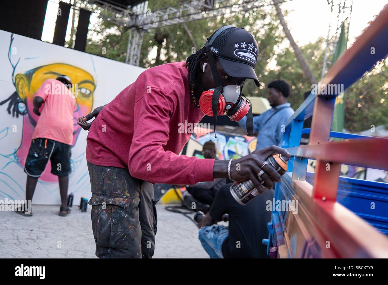 Dakar, Senegal. 18th May, 2025. A graffiti artist spray paints a ...