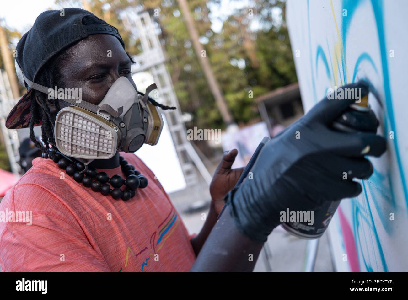 Dakar, Senegal. 18th May, 2025. A graffiti artist spray paints a canvas ...