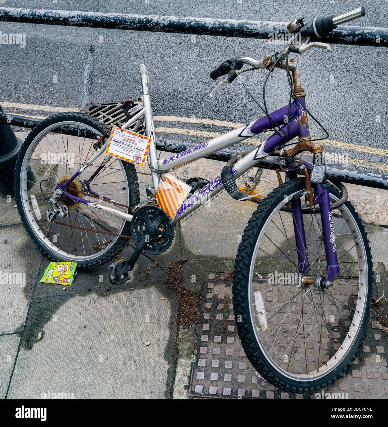 Abandoned bike chained to railings with notice from Council warning of ...
