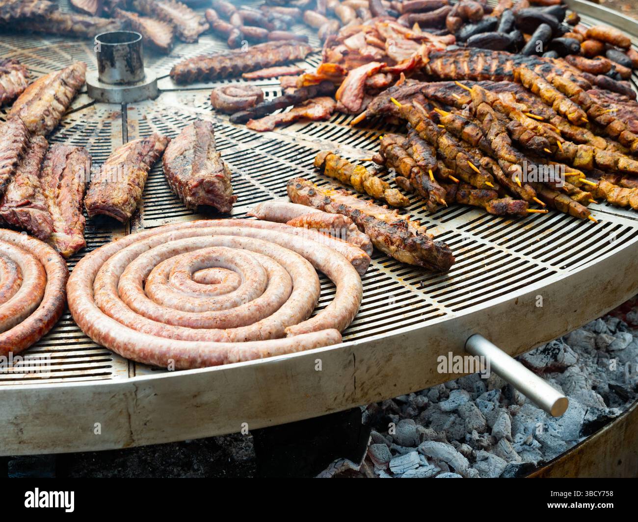 Different types of sausages and meat on grill Stock Photo - Alamy