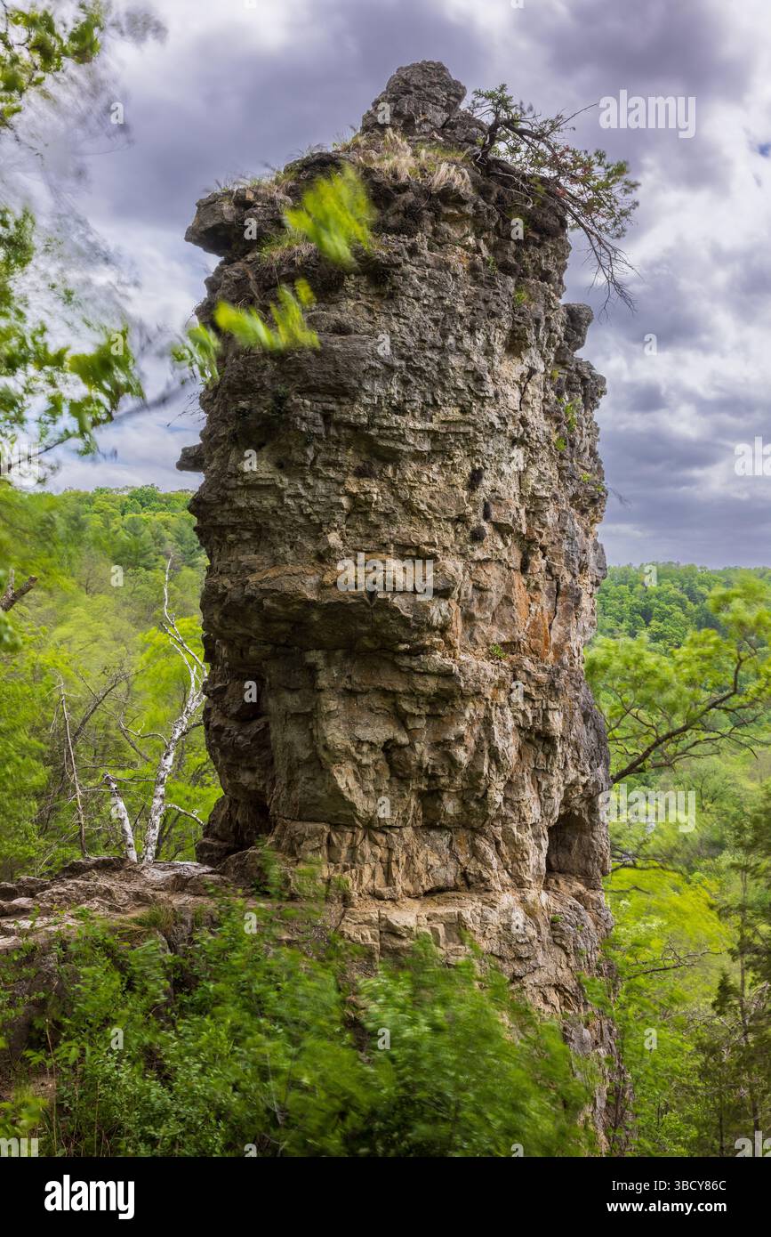 Chimney Rock - A rock formation on a hill in the woods on a breezy day ...