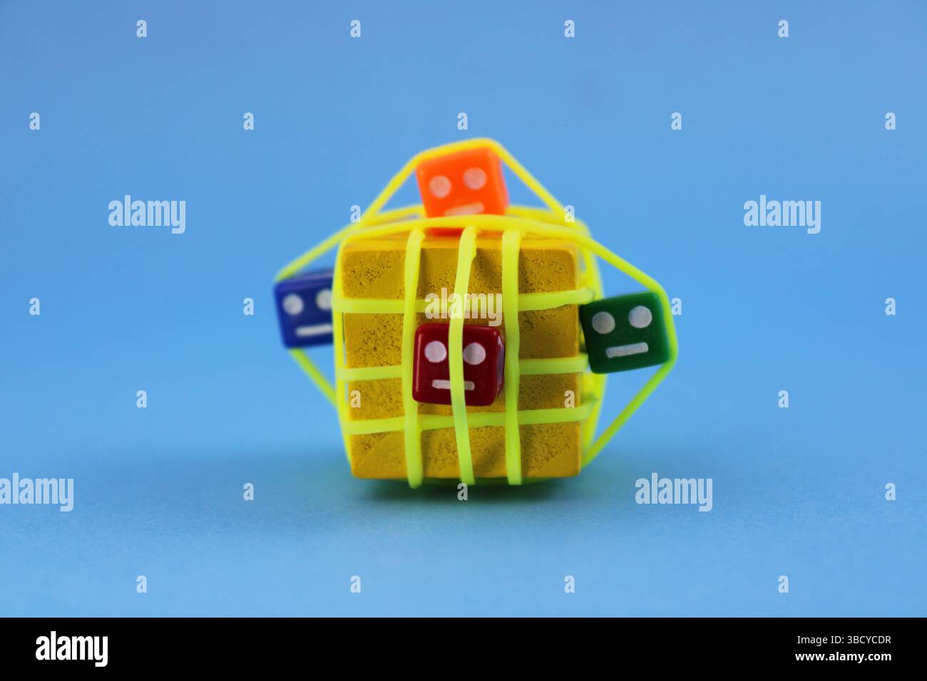 Sad faces trapped in a cube with rubber bands Stock Photo - Alamy