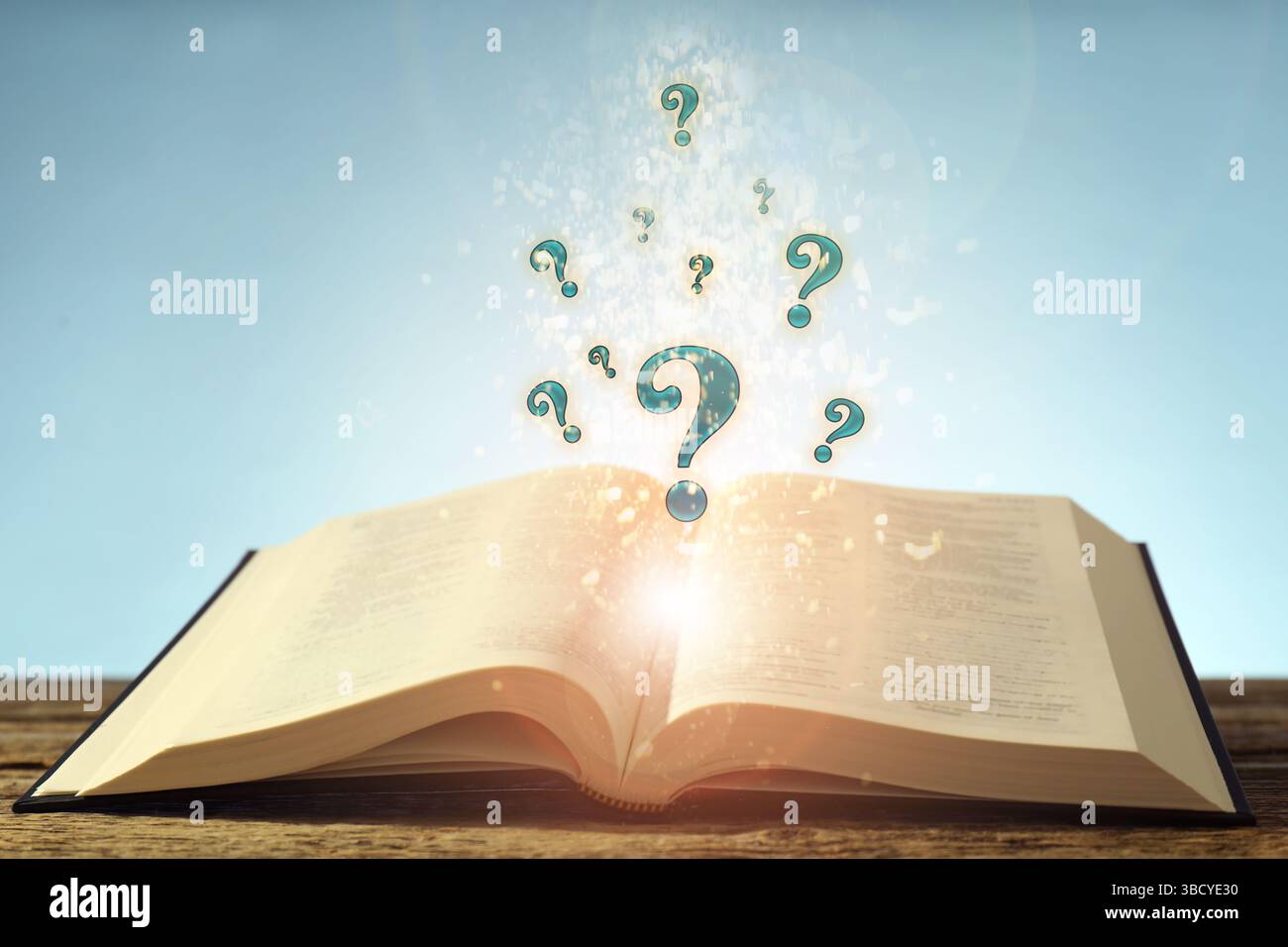 Question marks and lights flying out of open book on table against ...