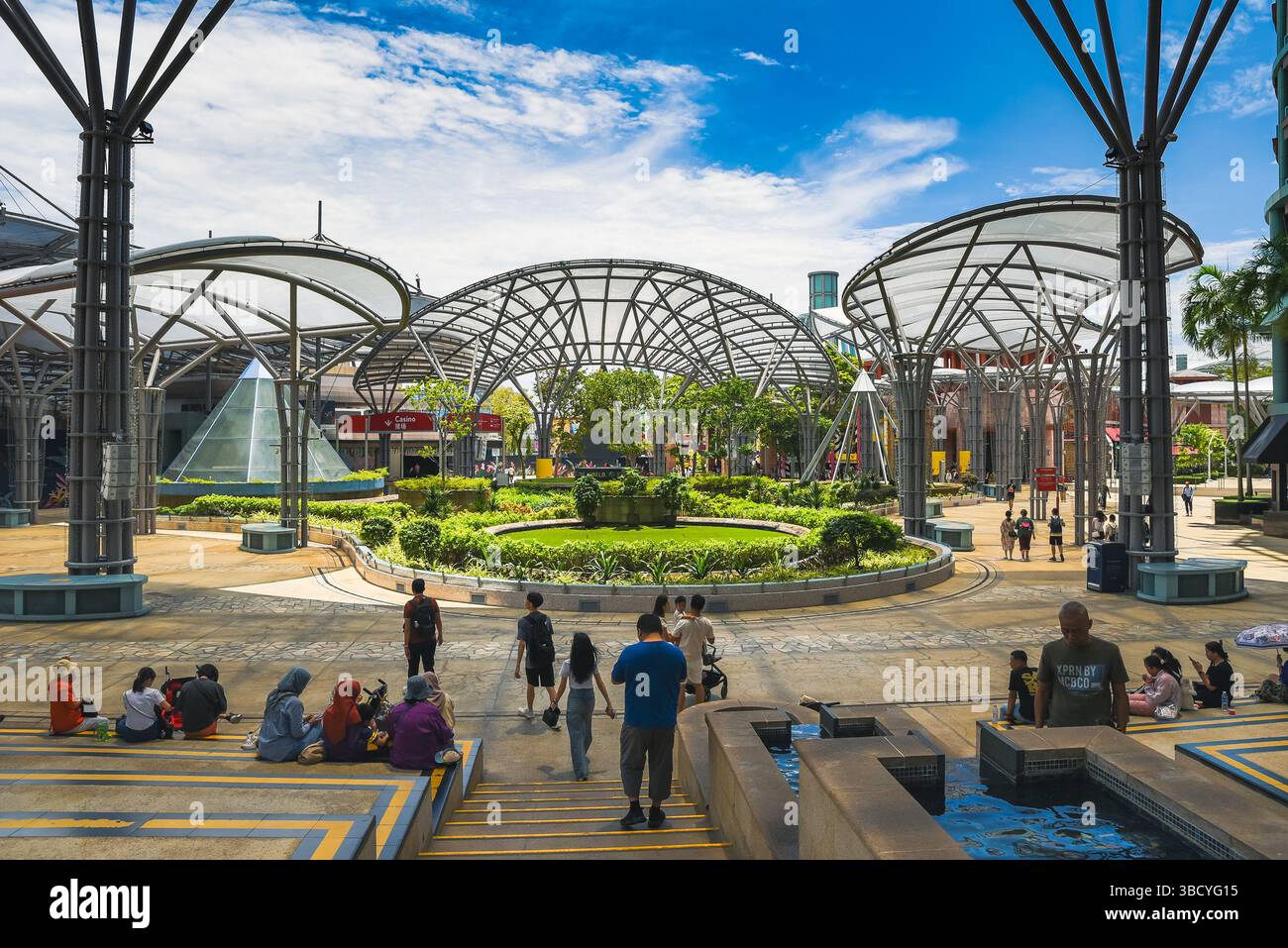Singapore, Singapore - 4 April 2025: People walk and relax near canopy ...