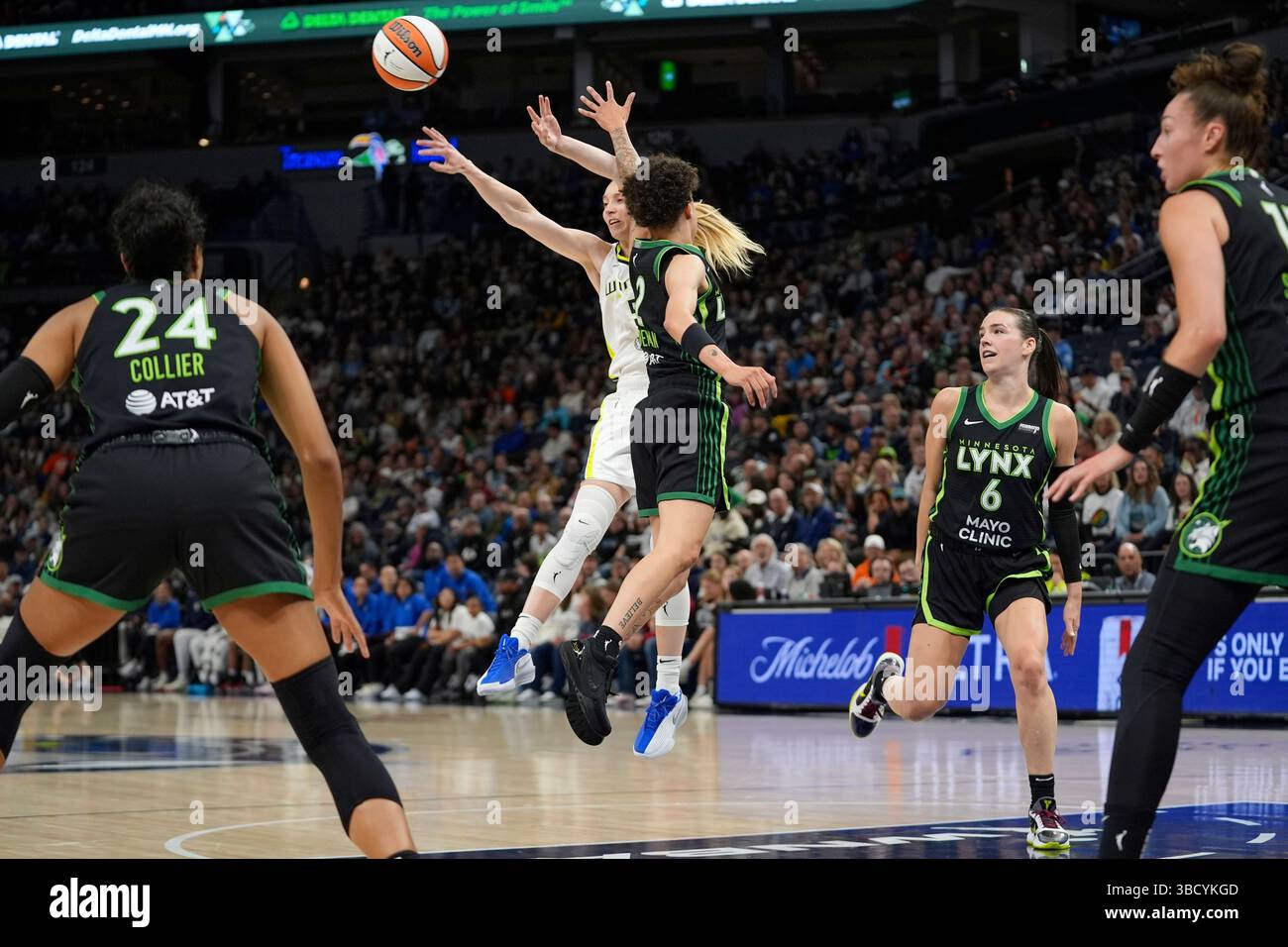Dallas Wings guard Paige Bueckers (5), back, passes around Minnesota ...