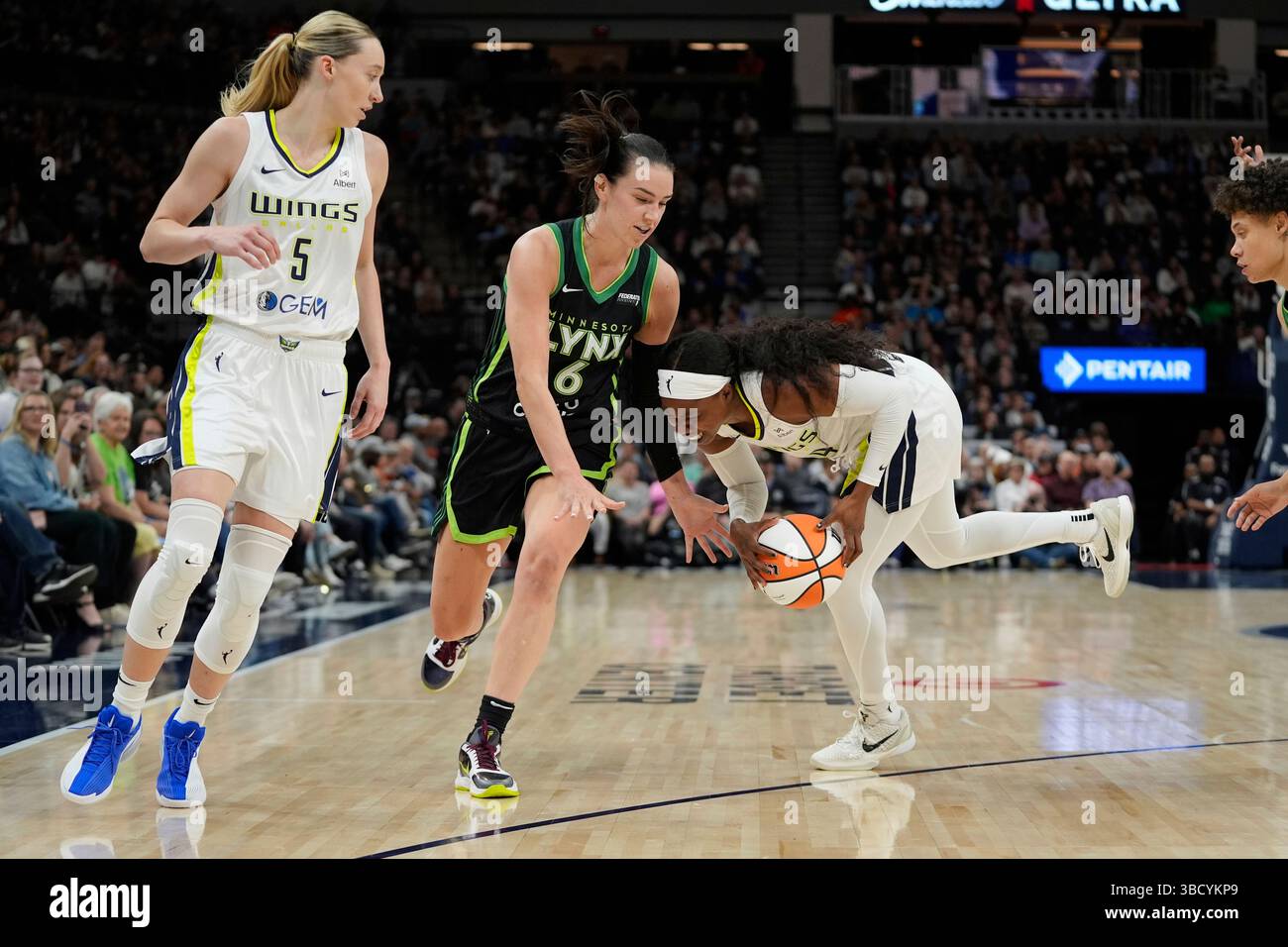 Dallas Wings guard Arike Ogunbowale (24), right, is fouled by Minnesota ...