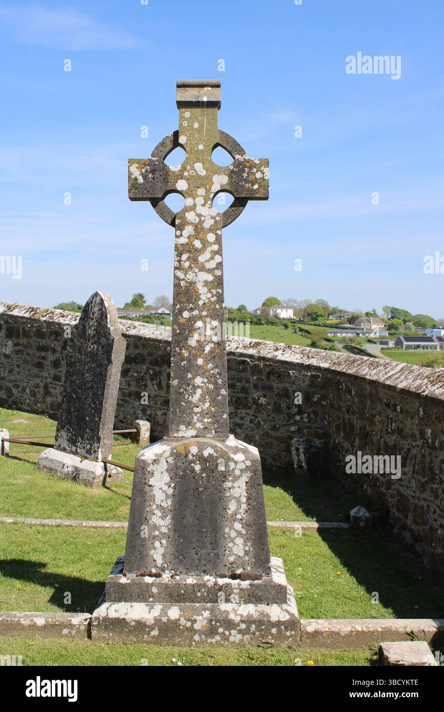 Celtic cross covered with lichens at a cemetery at the Rock of Cashel ...