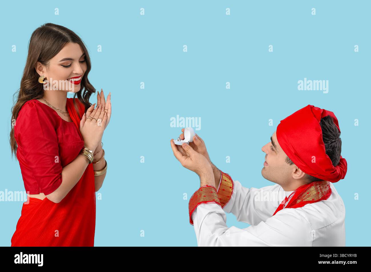 Young Indian man with engagement ring making proposal to his beloved ...