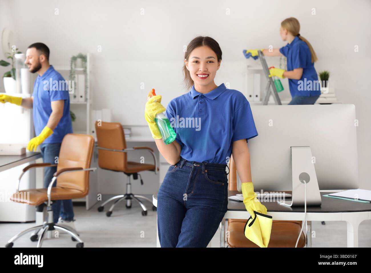 Female Asian janitor with detergent and rag in office Stock Photo - Alamy
