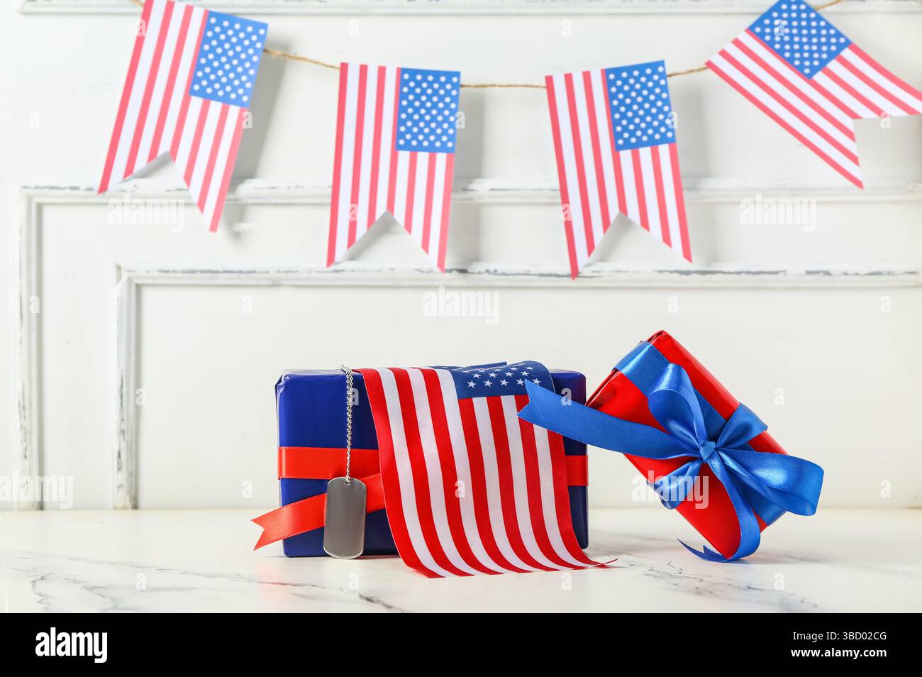USA flag with gift boxes on table near white wall. Independence Day ...