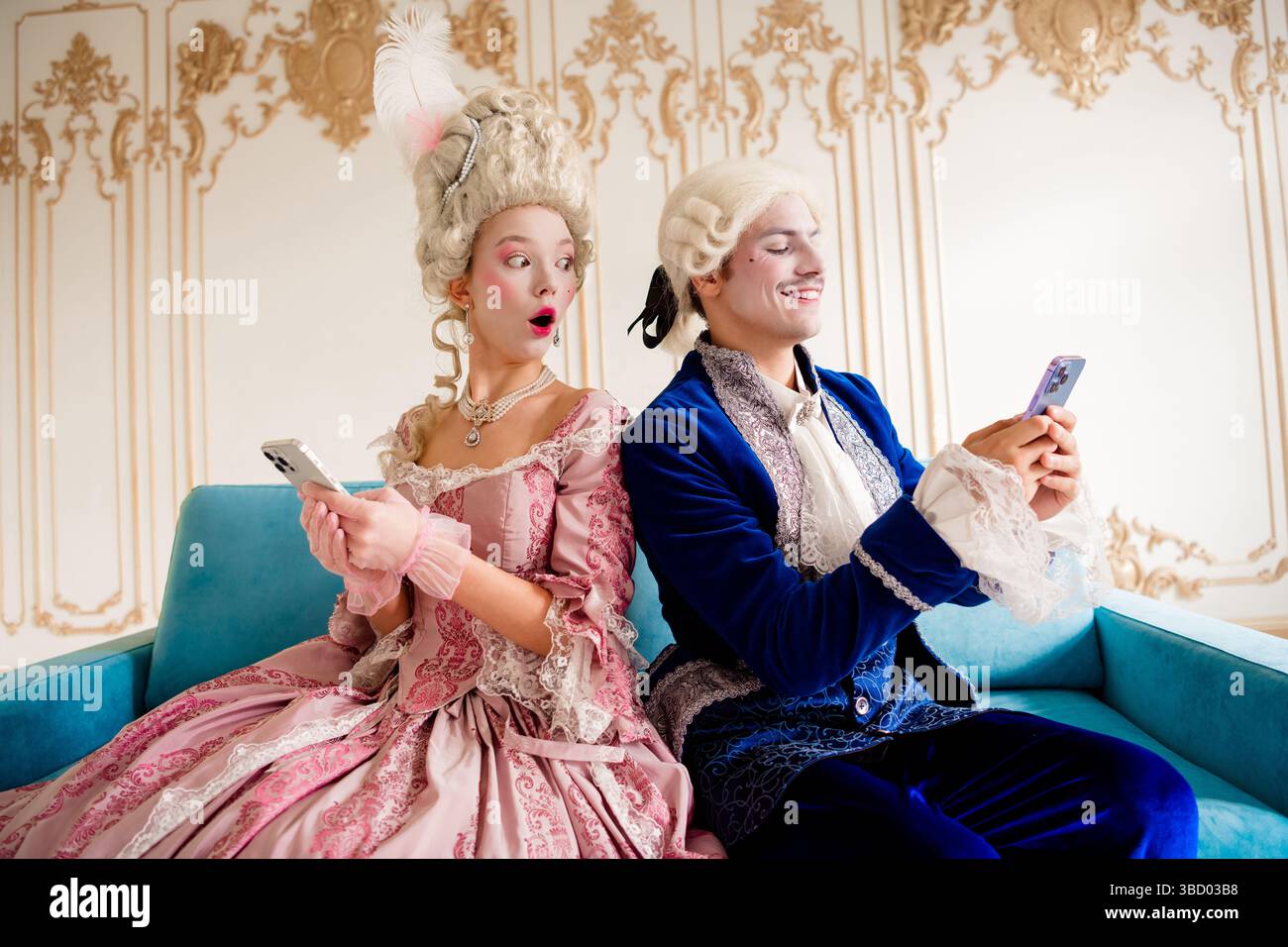 Elegant Couple in Baroque Costumes Using Smartphones in a Luxurious ...