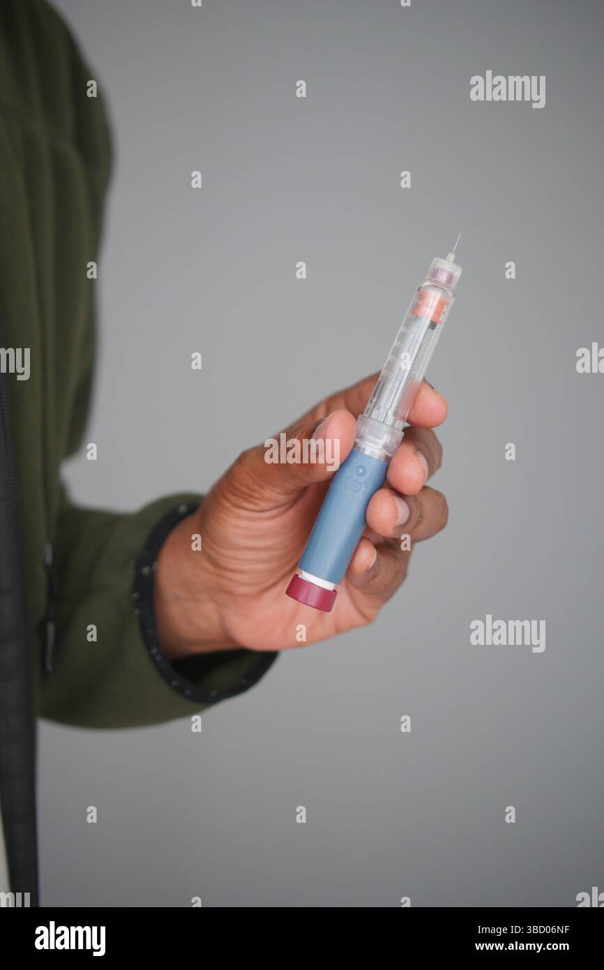 Holding a medical injection device for diabetes management Stock Photo ...