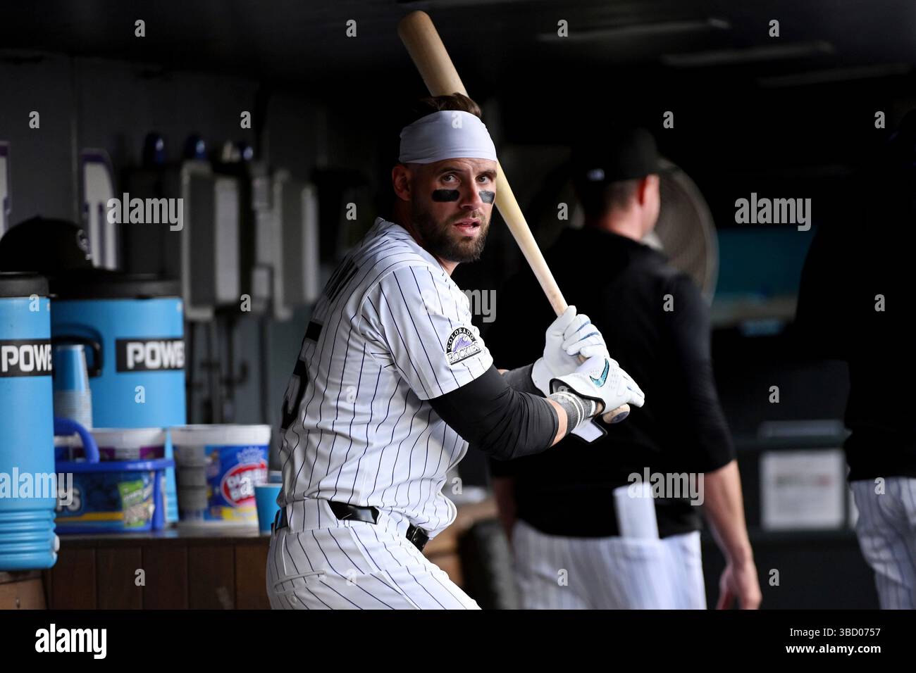 Colorado Rockies' Nick Martini (35) practices his swing in the dugout ...