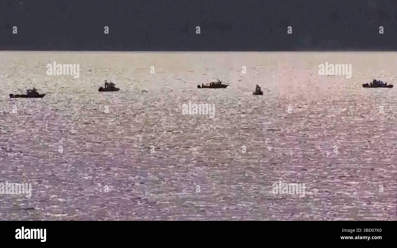 This image taken from video provided by KOMO shows boats searching for ...