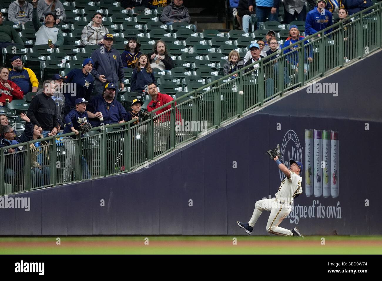 Milwaukee Brewers' Isaac Collins makes a sliding catch during the fifth ...