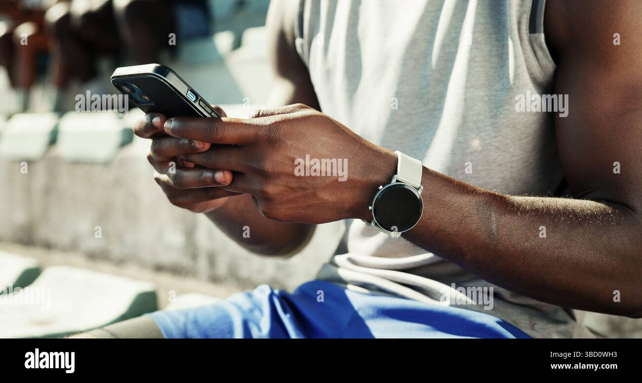 Athlete, hands and typing with phone and man in stadium for running ...