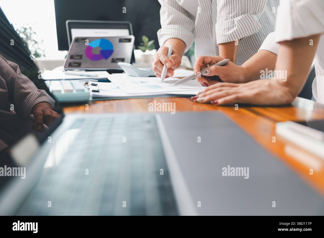 Teamwork with business people analysis cost graph on desk at meeting ...