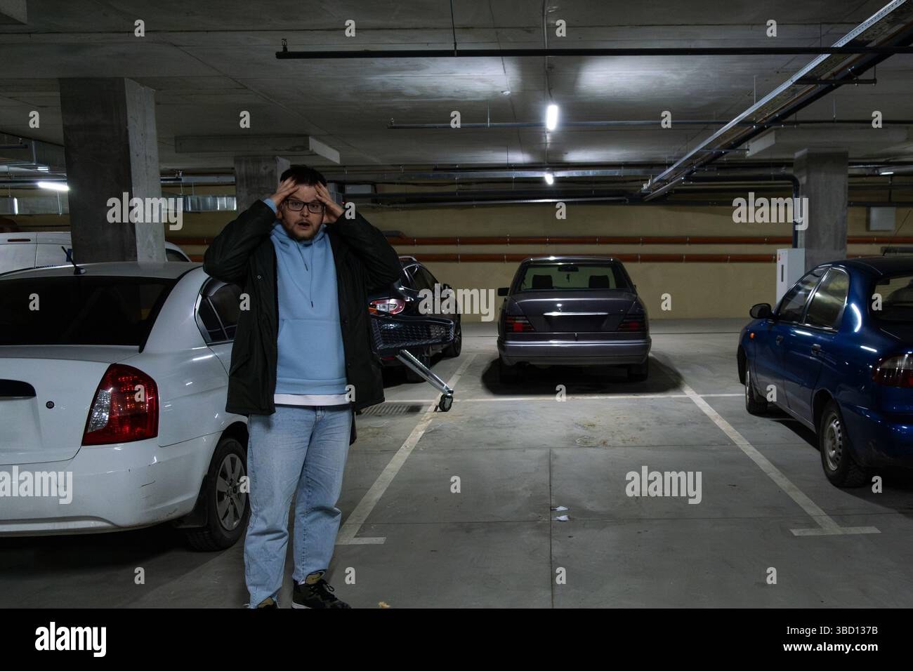 Person in Underground Parking Garage Figure Out of Stolen Car Stock ...