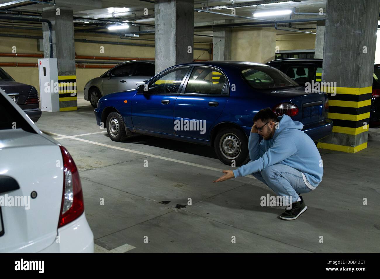 Person in Underground Parking Garage Figure Out of Stolen Car Stock ...