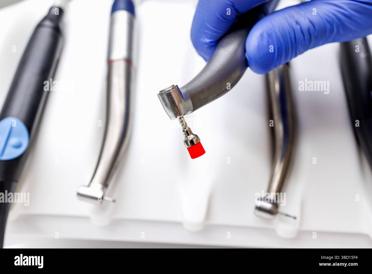 Dental Handpiece with Red Polisher Held by Gloved Hand Stock Photo - Alamy