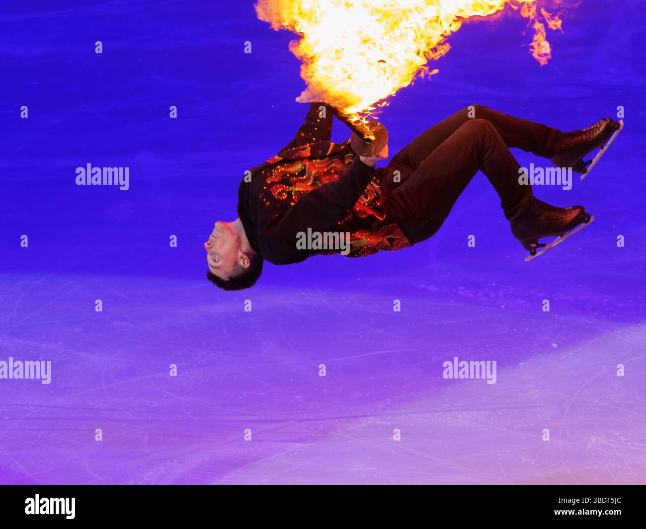 Skater Performing an Artistic Performance on the Ice Rink with Flaming ...