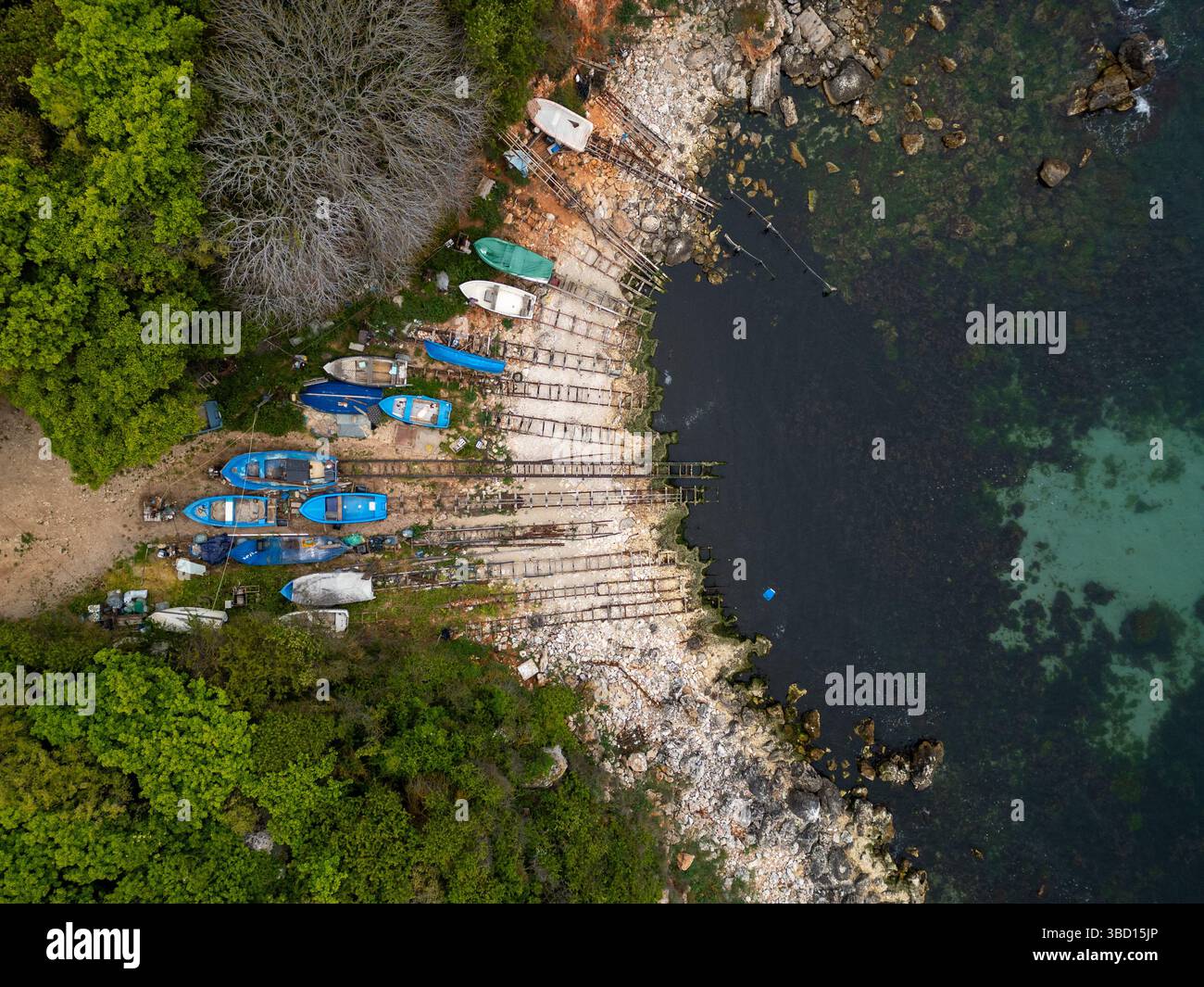 Aerial view of small boatyard with fishing boats and old slipways near ...