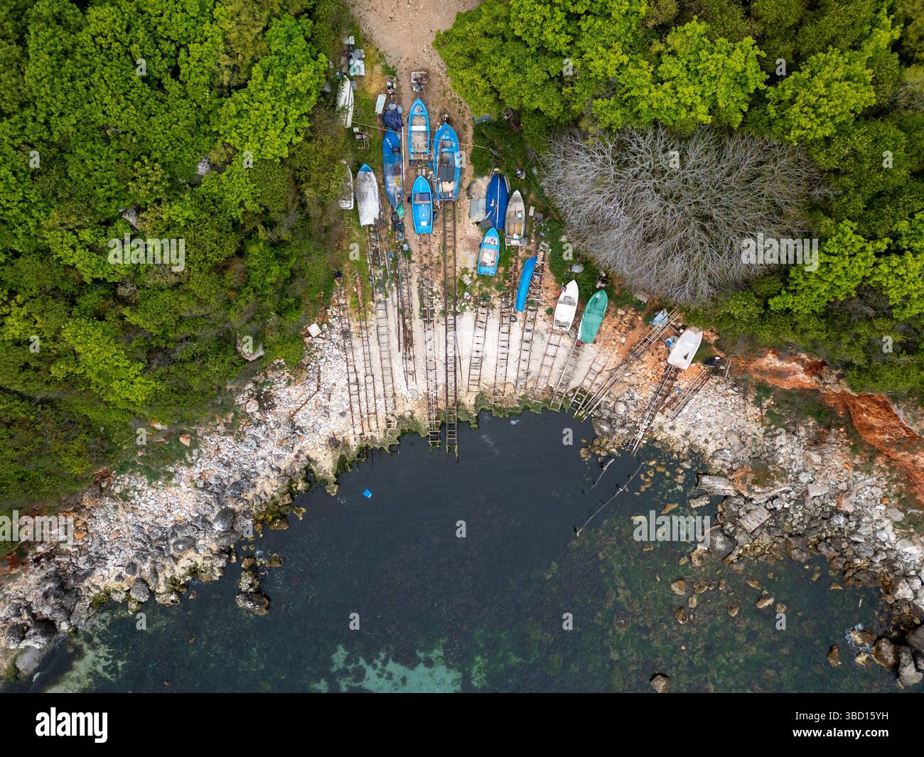 Aerial view of small boatyard with fishing boats and old slipways near ...