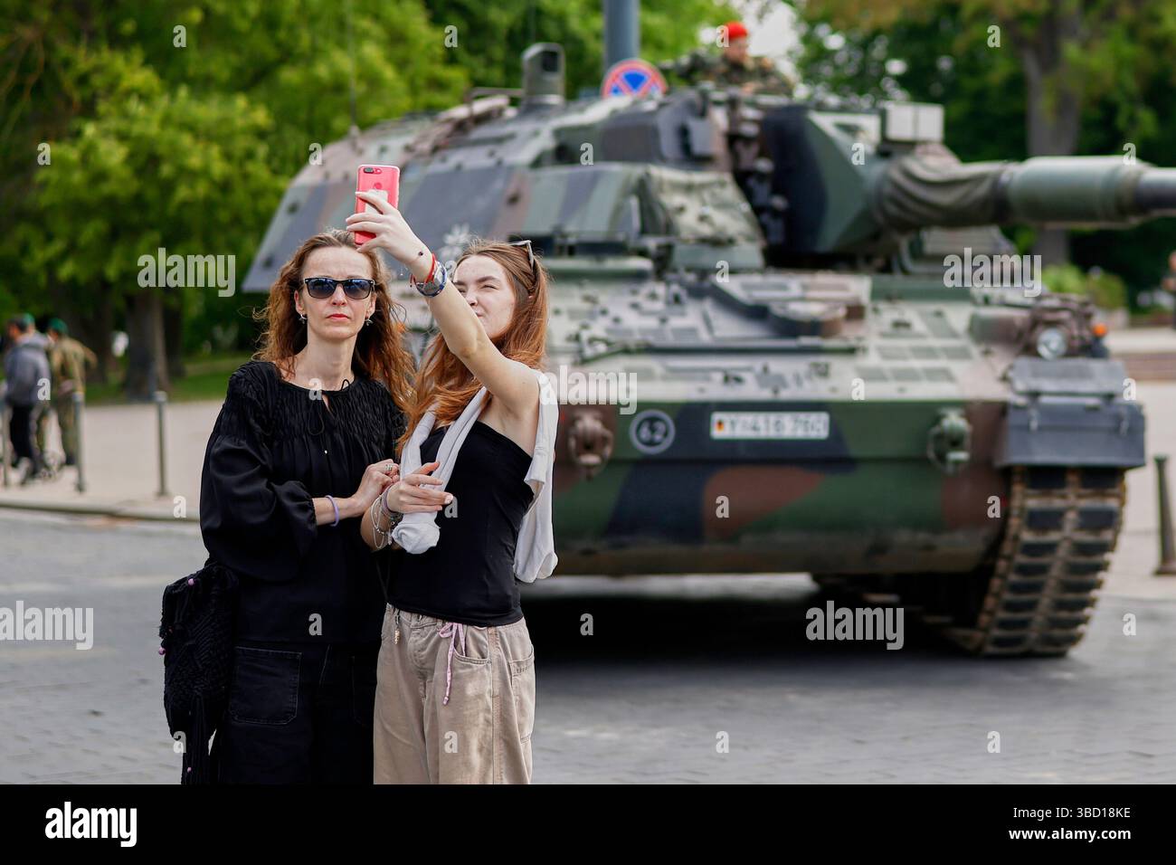 Two women make a selfie at a German tank before the formal inauguration of a German brigade for ...