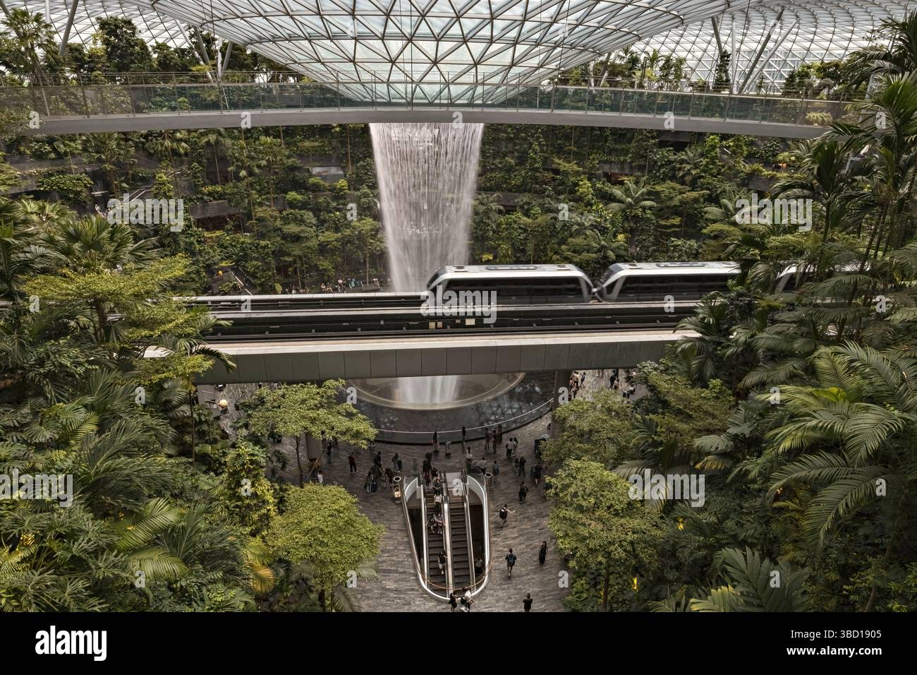 Jewel Rain Vortex waterfall and the train running in the Changi ...