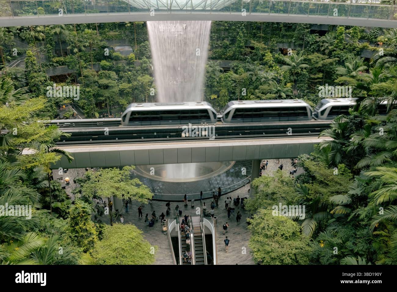 Jewel Rain Vortex waterfall and the train running in the Changi ...